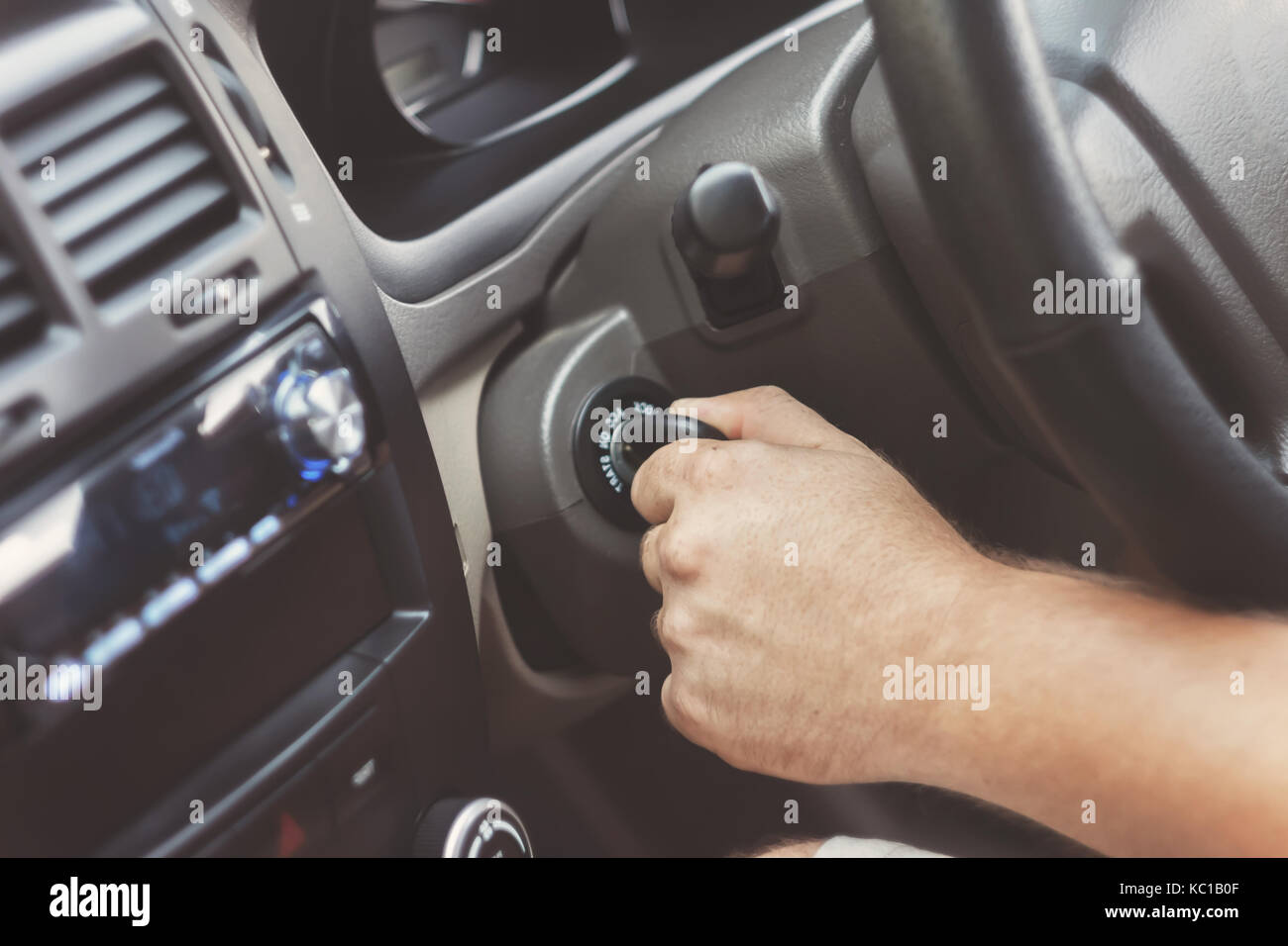 man's hand starts a car with the key in retro toning Stock Photo - Alamy