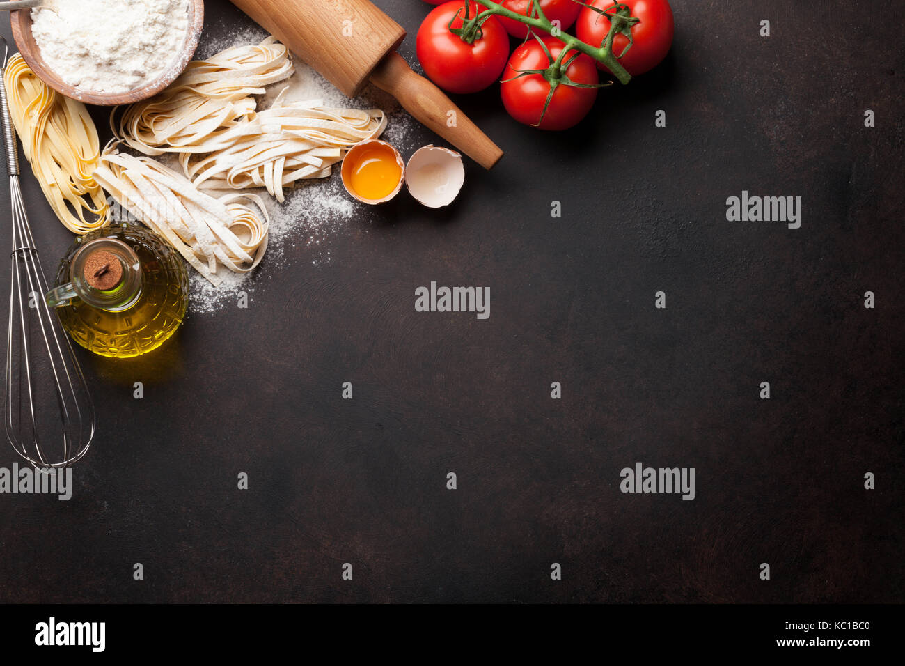 Pasta cooking ingredients on wooden kitchen table. Top view with space ...