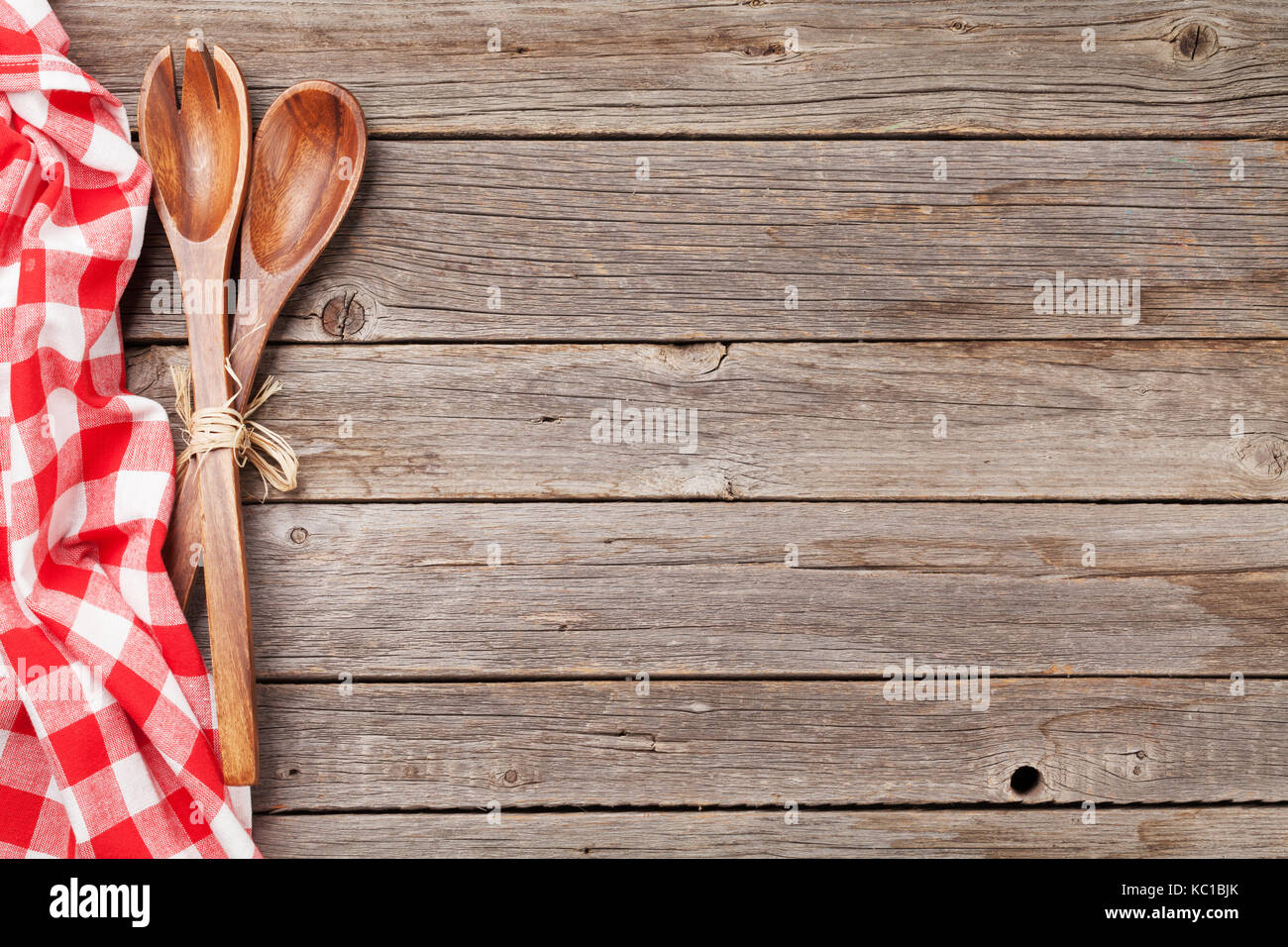 Kitchen towel and utensils on wooden cooking table. Top view with copy ...