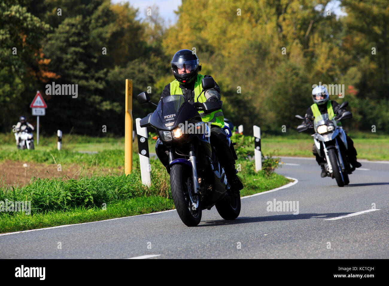 Bikers travelling on a country road in autumn, Mülheim an der Ruhr ...
