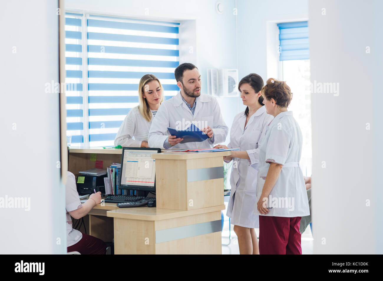 Doctor and receptionist at reception in a hospital Stock Photo - Alamy