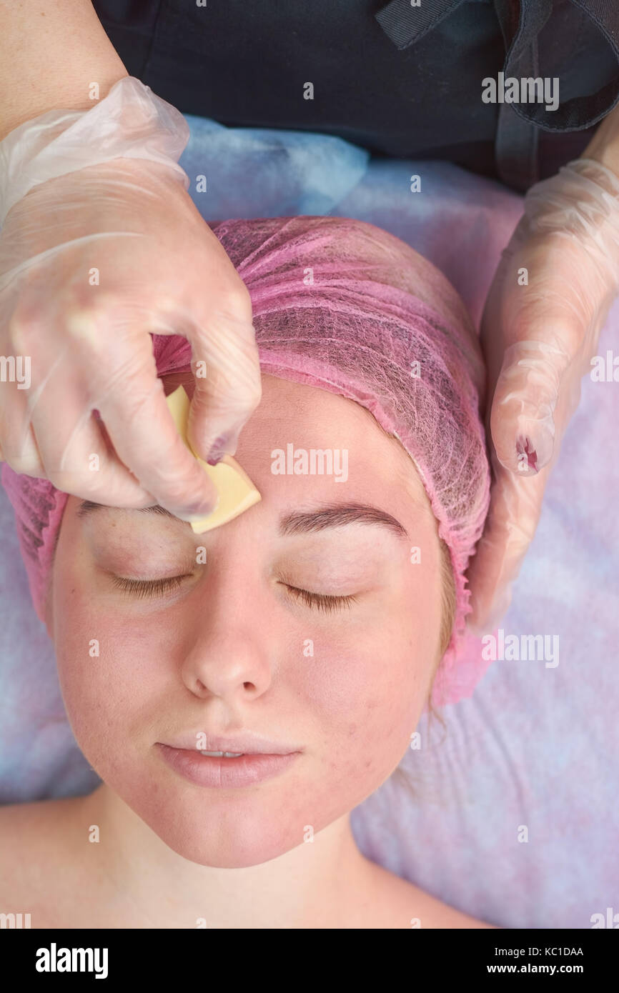 Hand applying foundation cream Stock Photo - Alamy