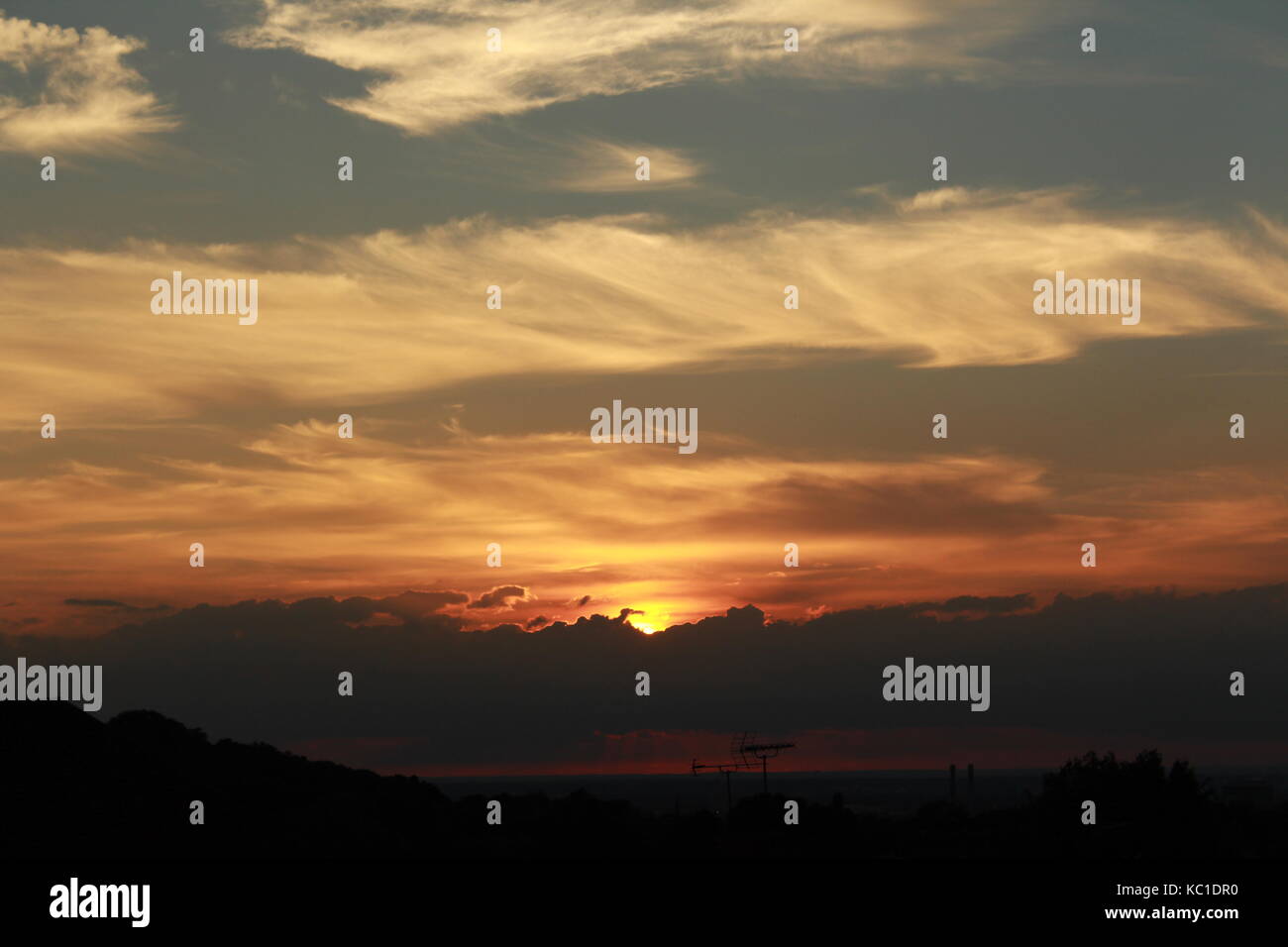 Golden sunset over a town at dusk Stock Photo - Alamy