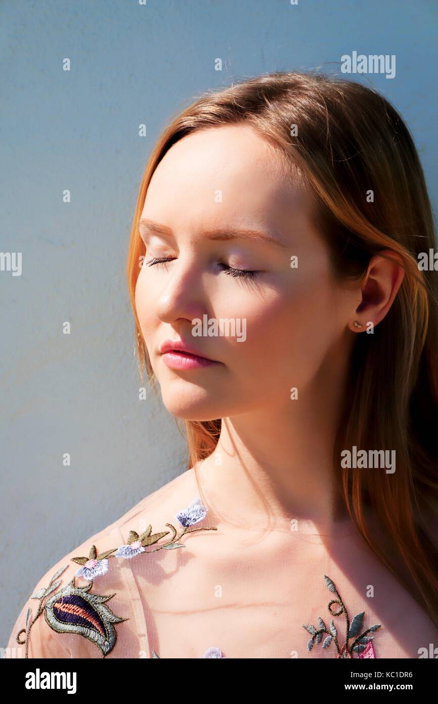 Portrait of Beautiful young woman facing sun with eyes closed Stock ...