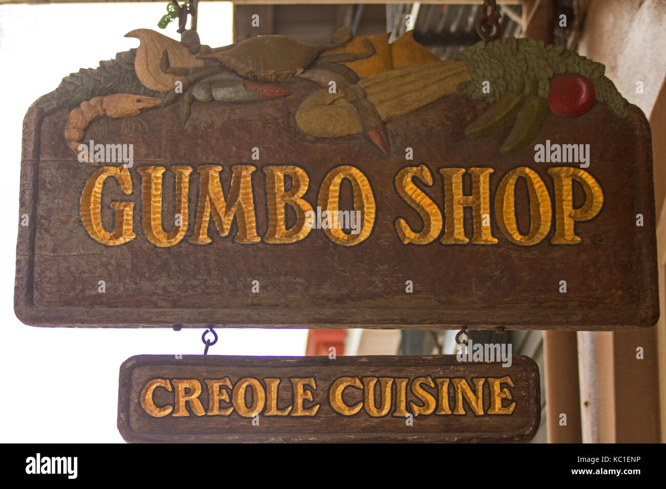 Wooden Gumbo Shop and Creole cuisine signs that hang near Jackson ...