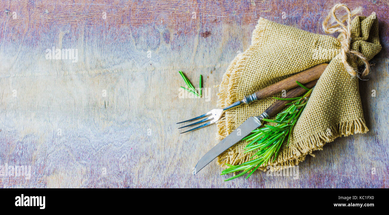 Rustic table setting with rosemary on dark wooden table with copyspace ...