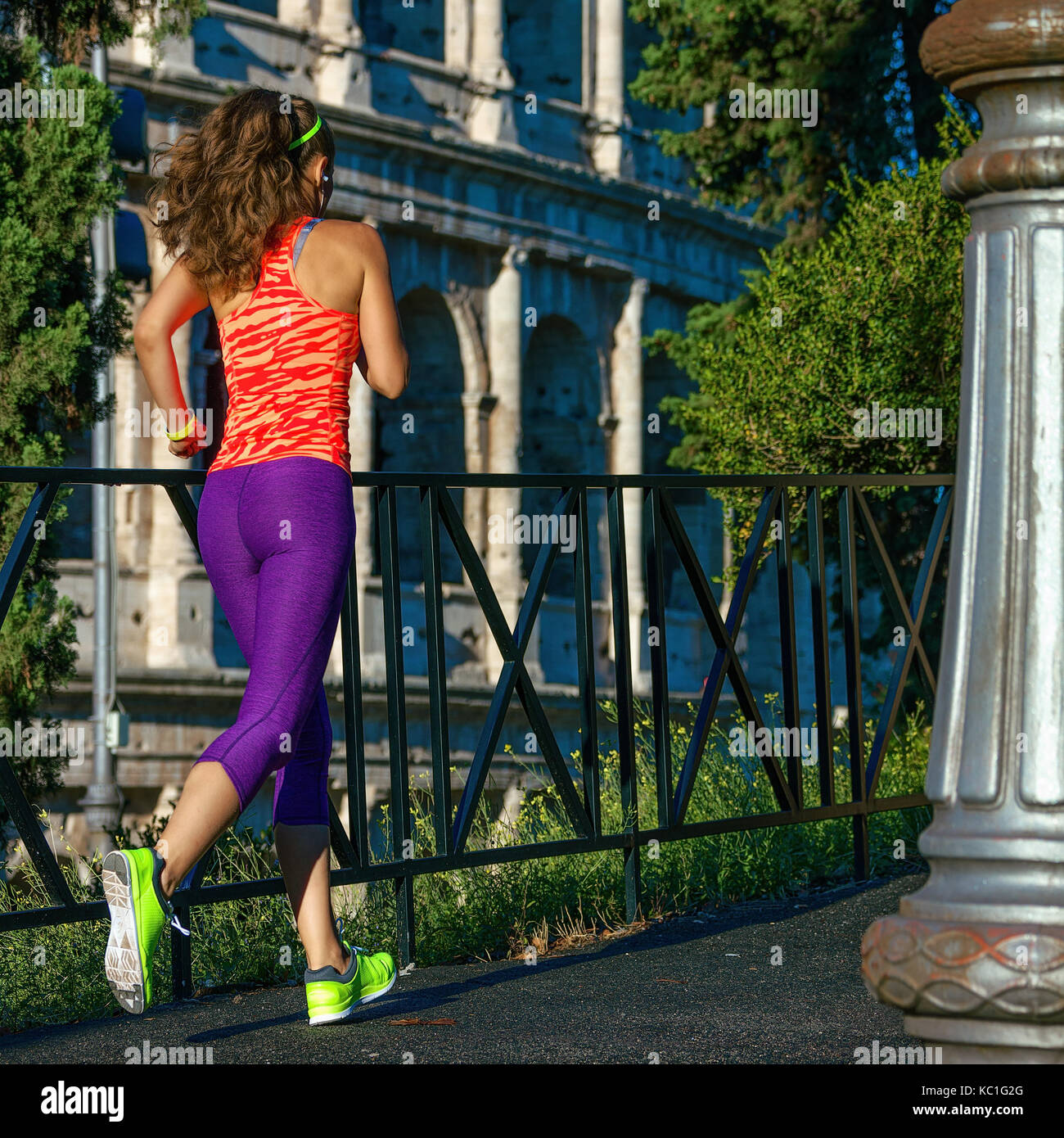 Gladiator inspiring trainings. Seen from behind young woman jogger in ...