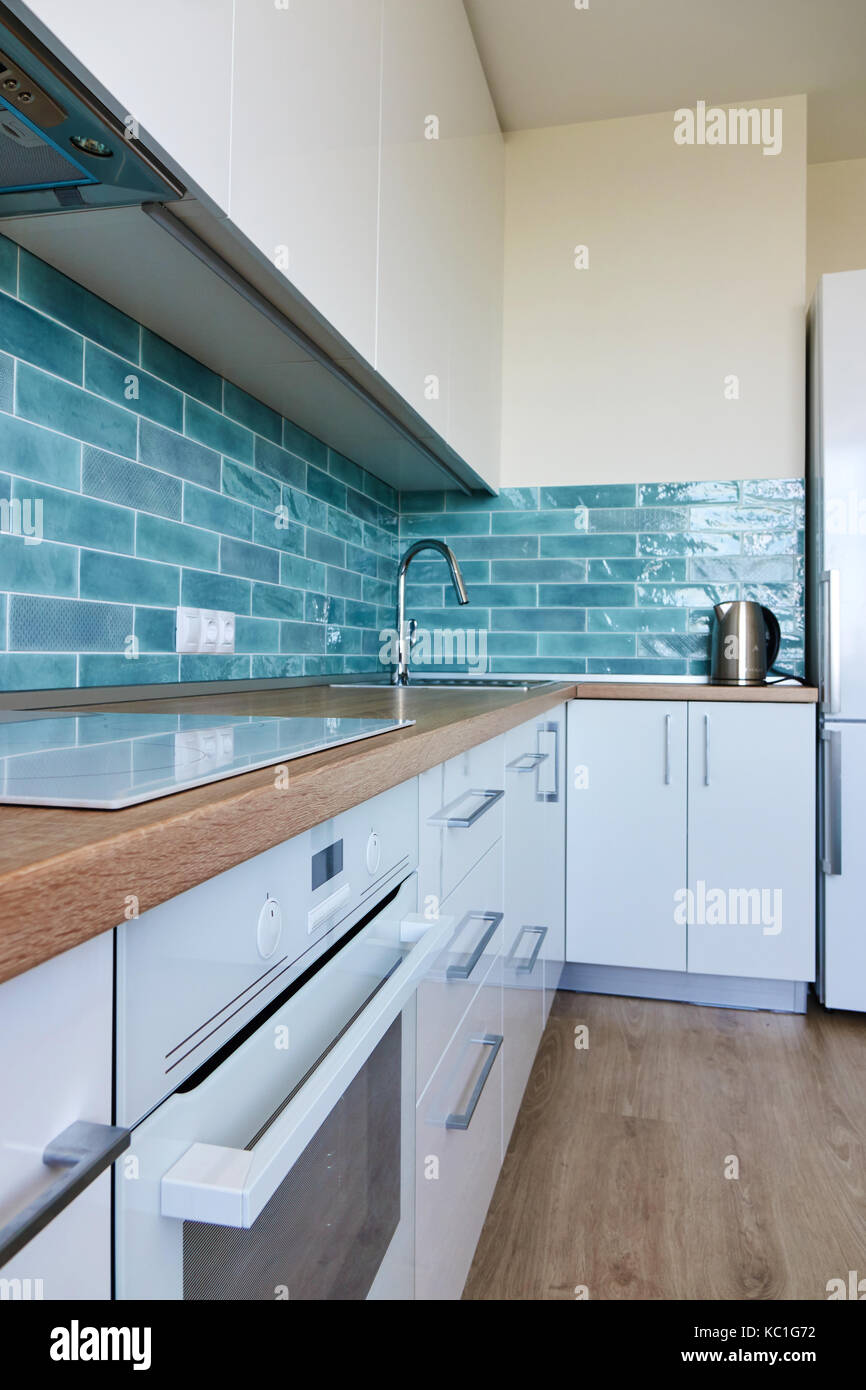 White glossy kitchen with modern appliances Stock Photo - Alamy