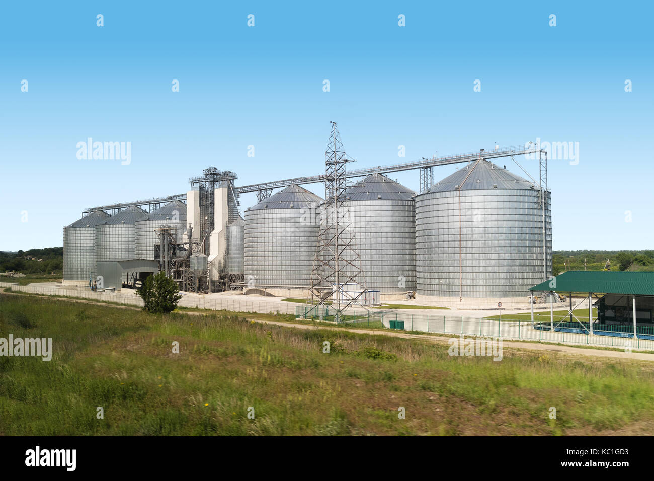 Green factory and blue sky Stock Photo - Alamy