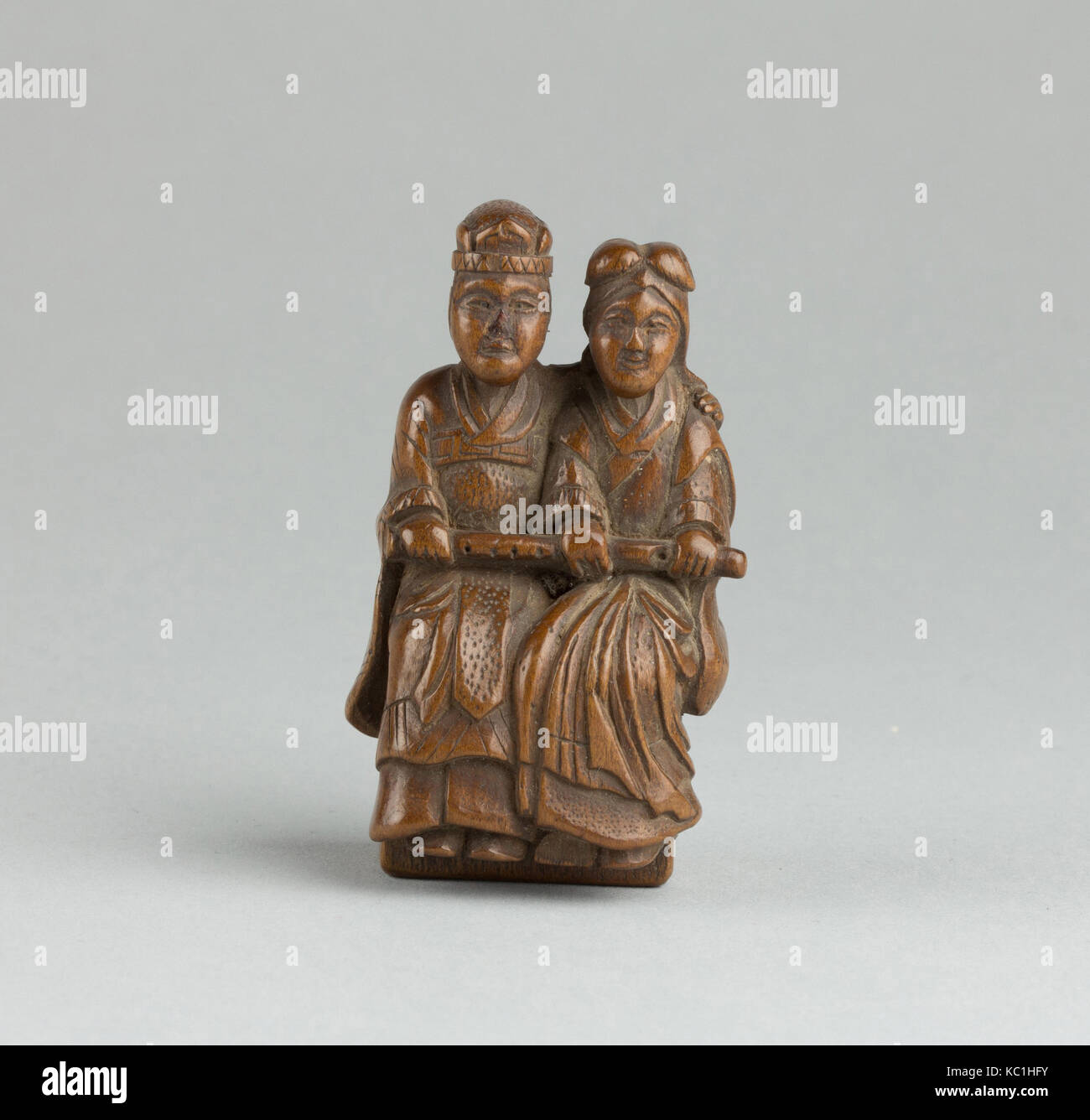 Netsuke of Man and Woman Sitting on a Box, 19th century Stock Photo - Alamy