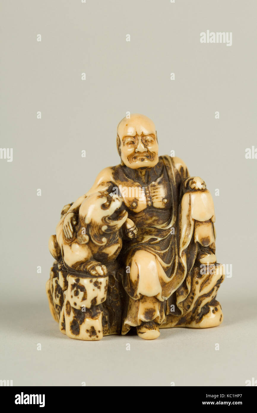 Netsuke of Man and a Qilin Sitting on a Rock, 19th century Stock Photo ...
