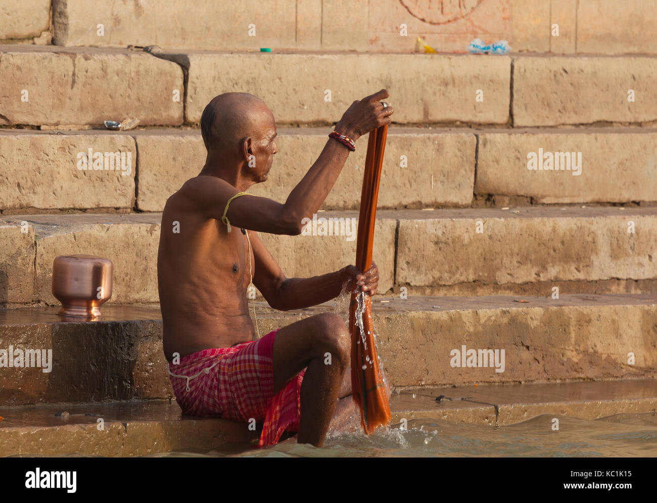 Pilgrim at ghat steps on river Ganges, Varanasi, Uttar Pradesh, India ...