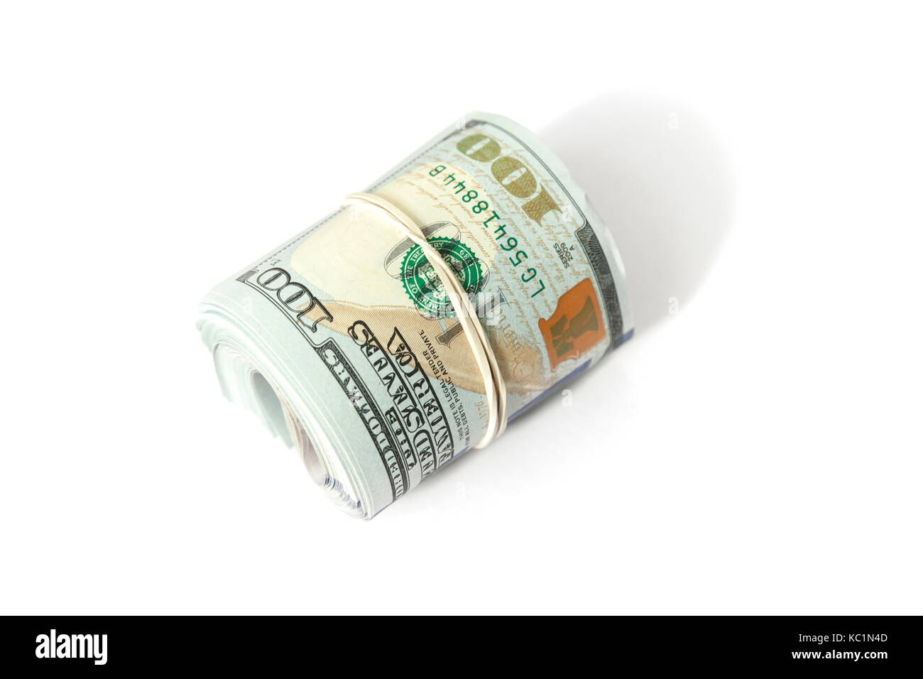 United States official currency, roll of One Hundred Dollars lays ...