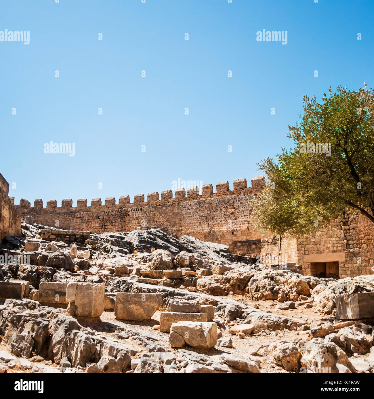 Medieval castle on Acropolis of Lindos with blue bay beneath, Rhodes ...
