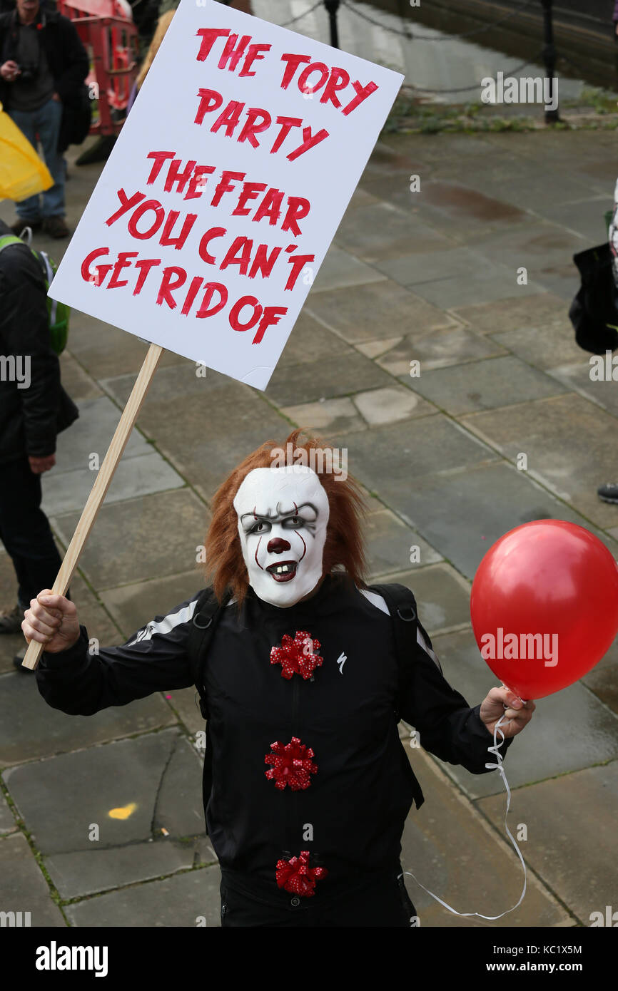 Manchester, UK. 1st October, 2017. A campaigner wearing a clown mask ...