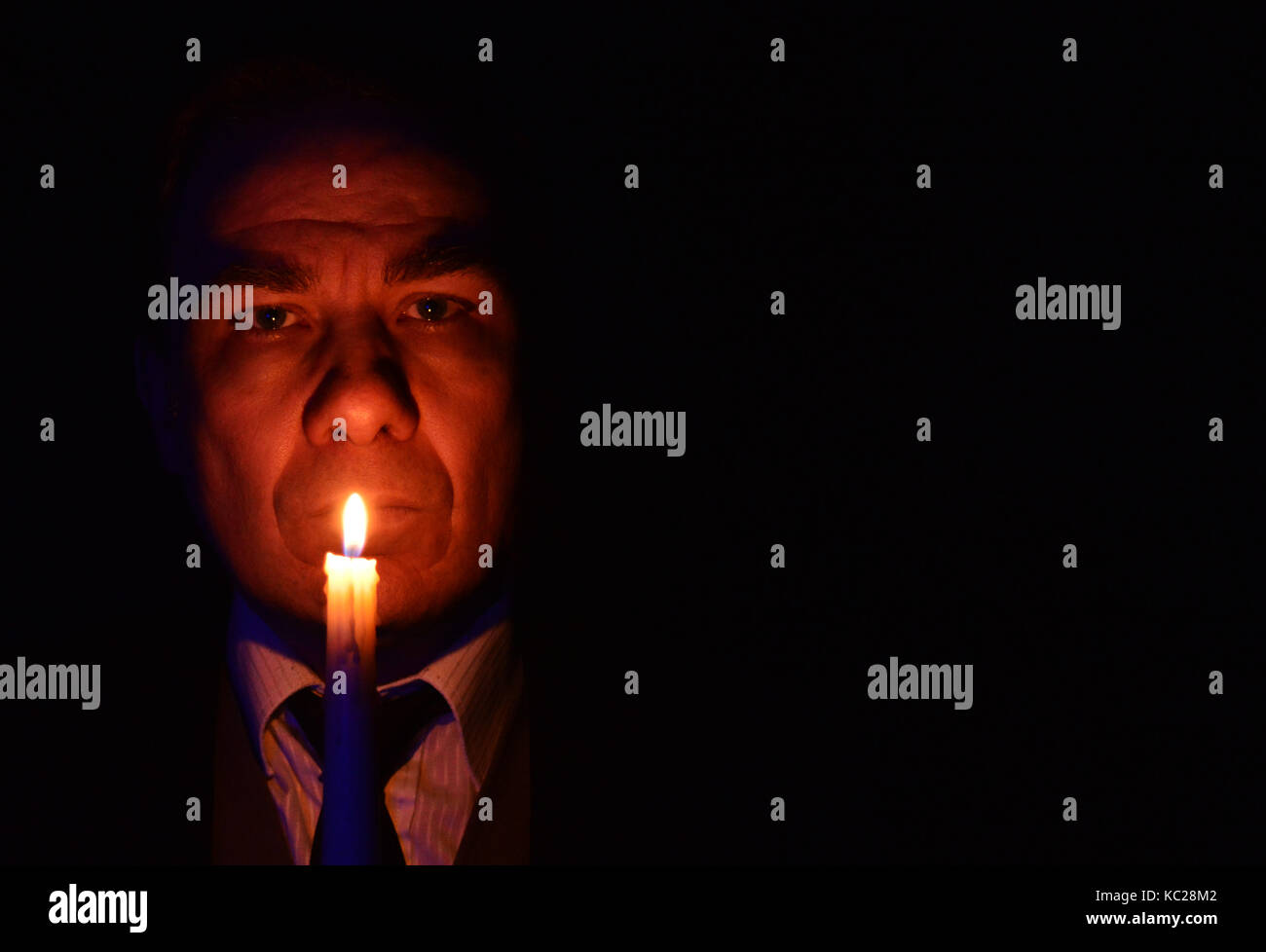 Butler with candle Stock Photo - Alamy