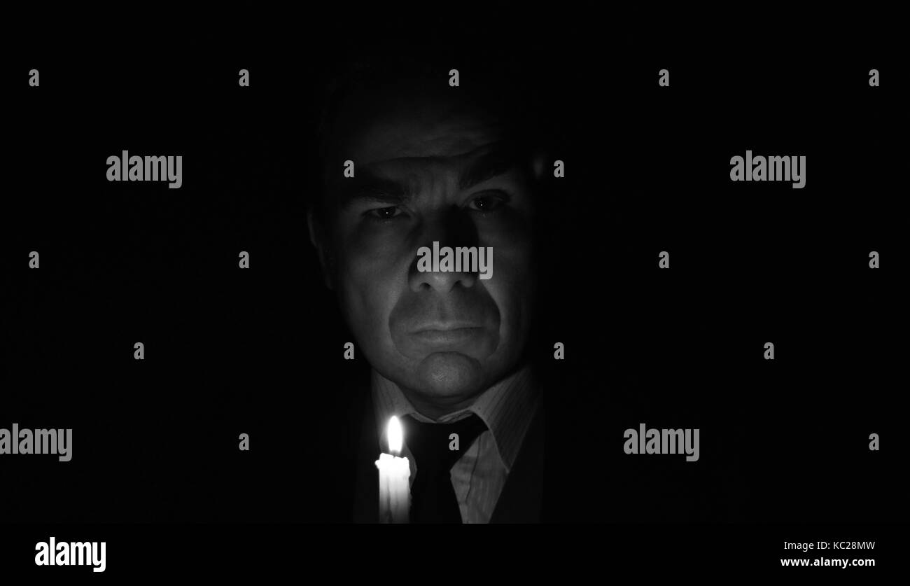 Butler with candle Stock Photo - Alamy