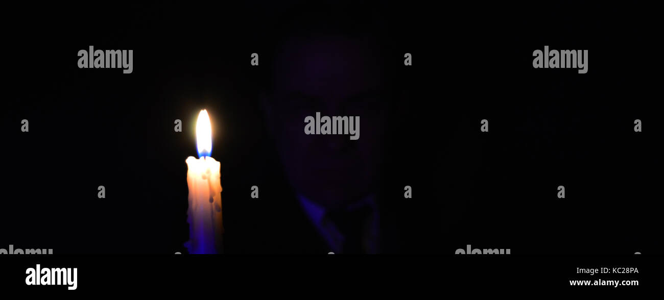 Butler with candle Stock Photo - Alamy