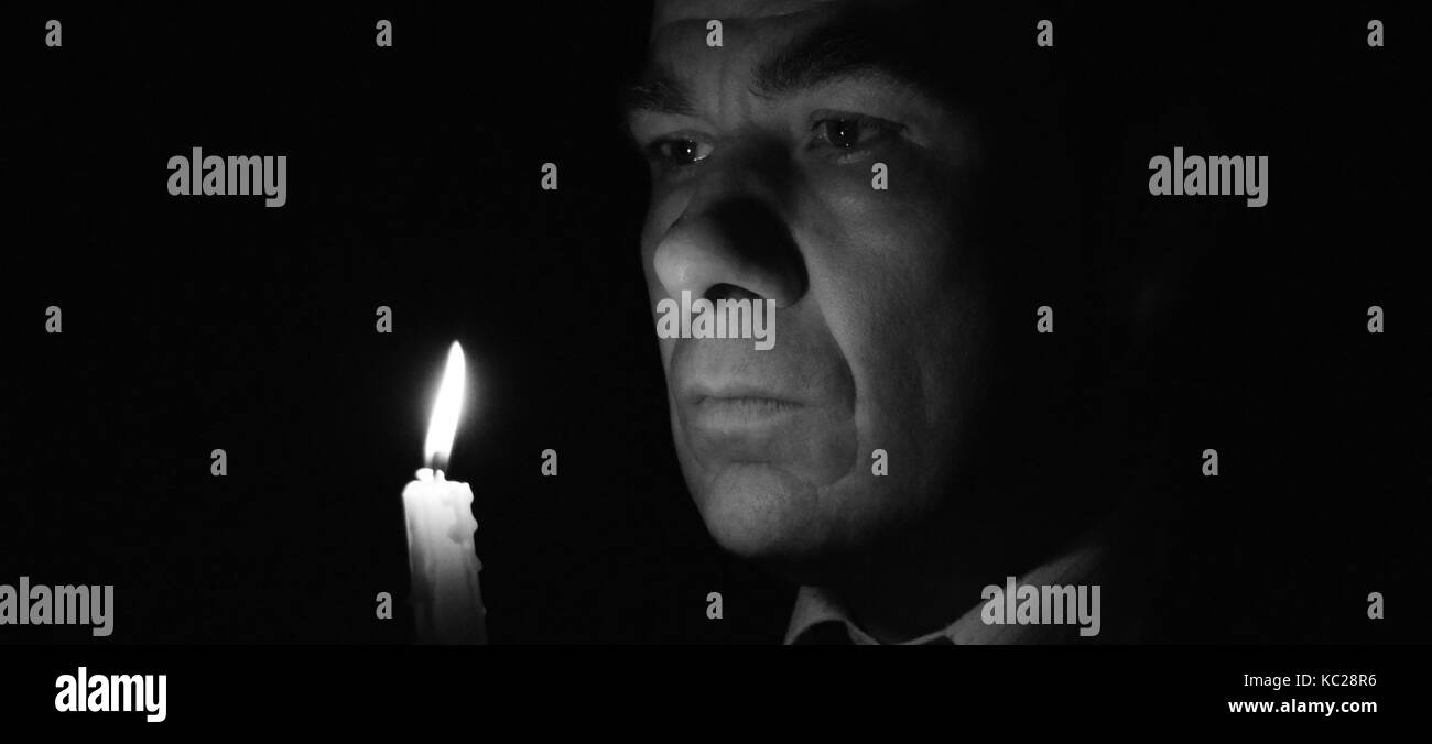 Butler with candle Stock Photo - Alamy