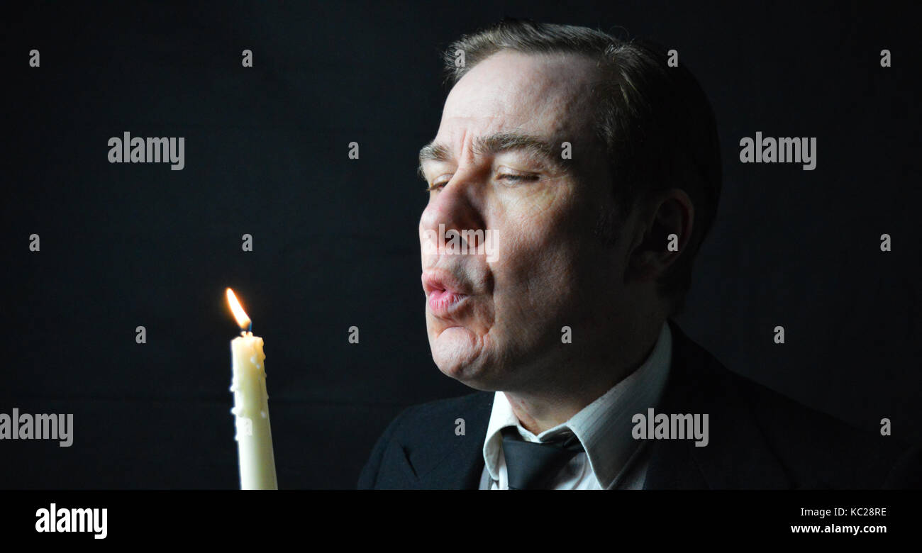 Butler with candle Stock Photo - Alamy