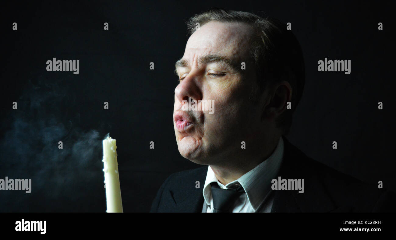 Butler with candle Stock Photo - Alamy