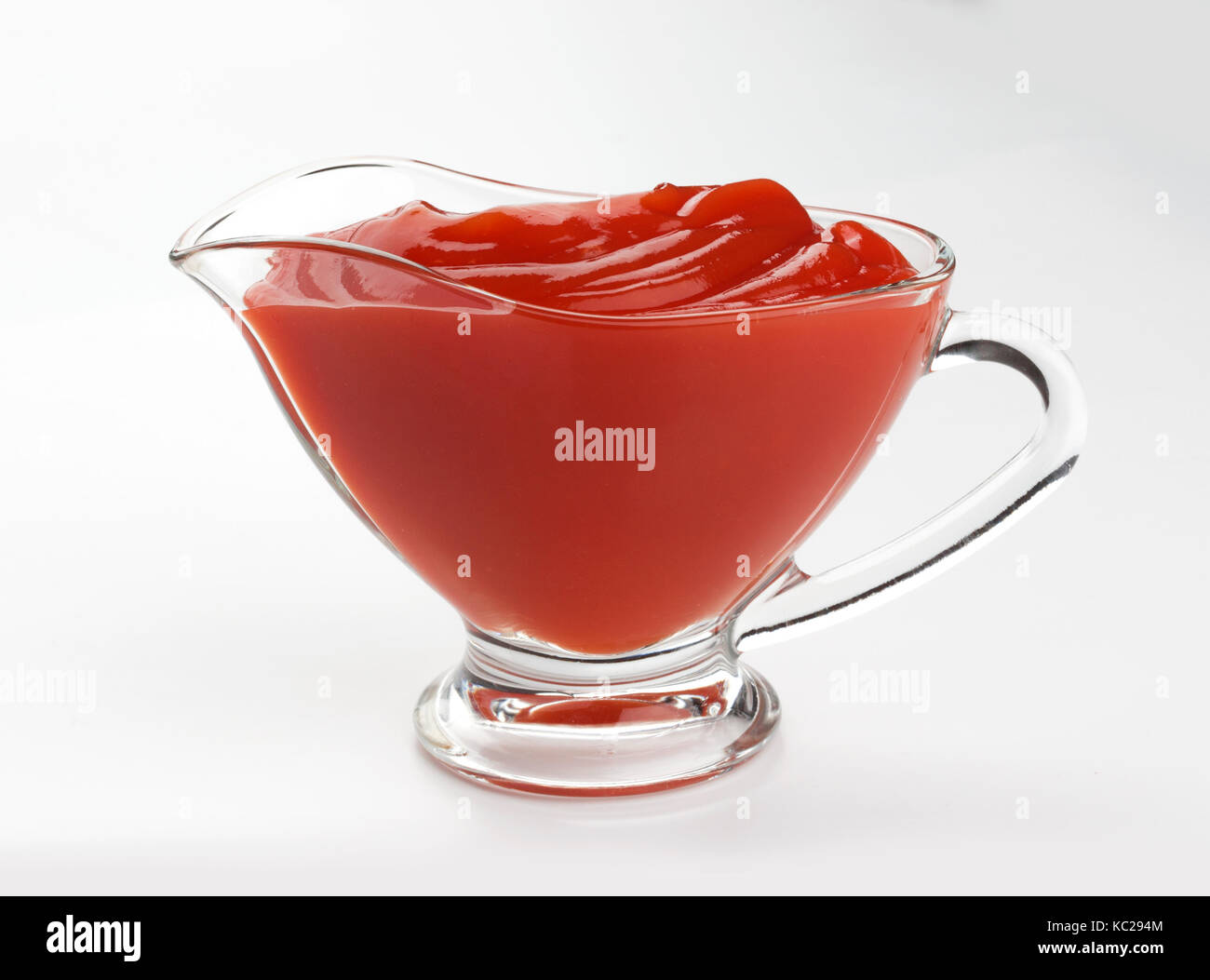 Ketchup in glass bowl isolated on white background Stock Photo - Alamy