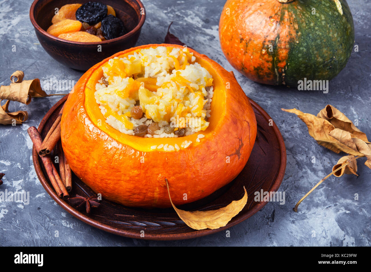 Pumpkin rice porridge cooked in pumpkin on autumn background Stock ...