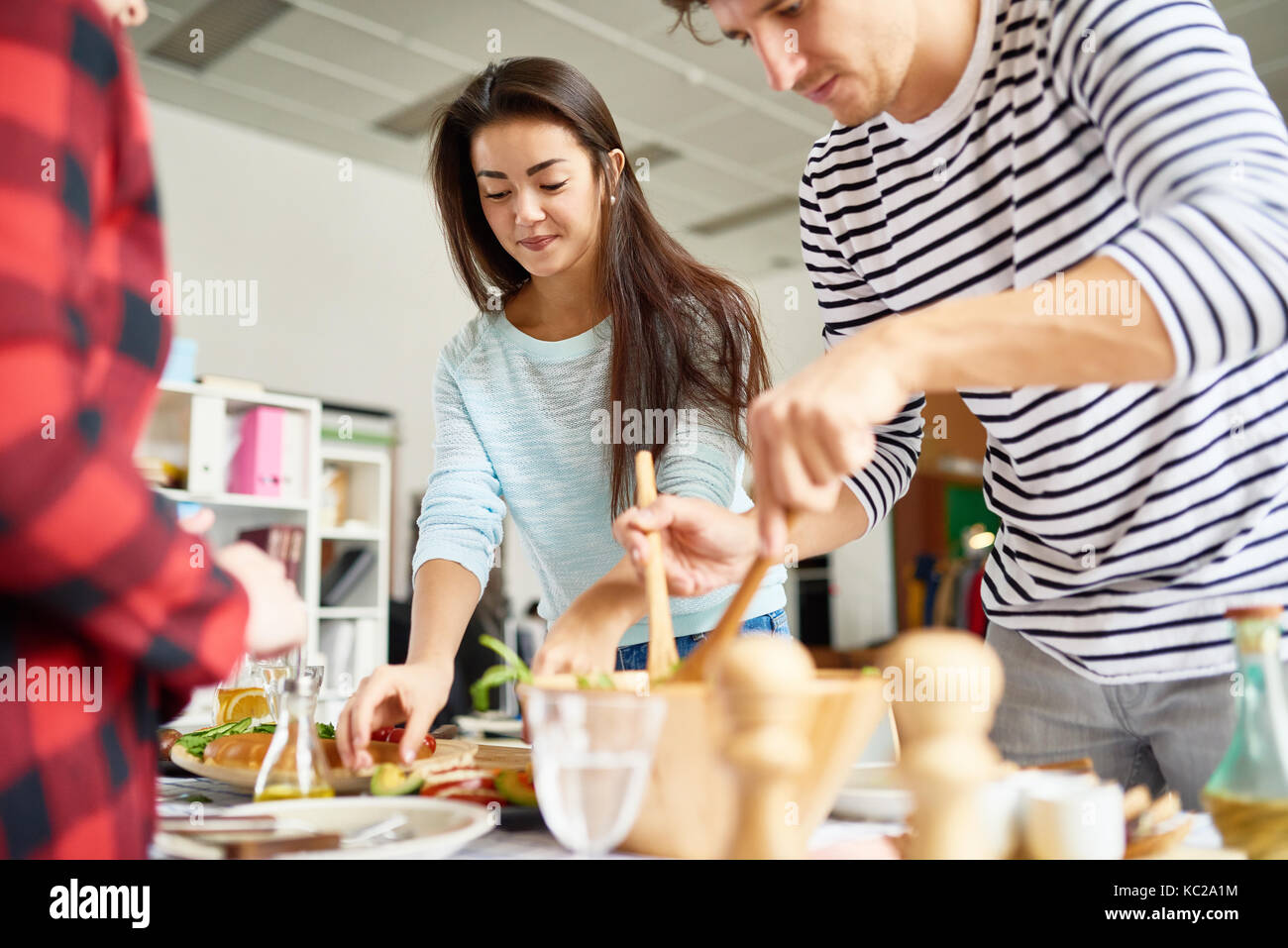 Portrait of beautiful Asian woman preparing dinner with friends setting ...