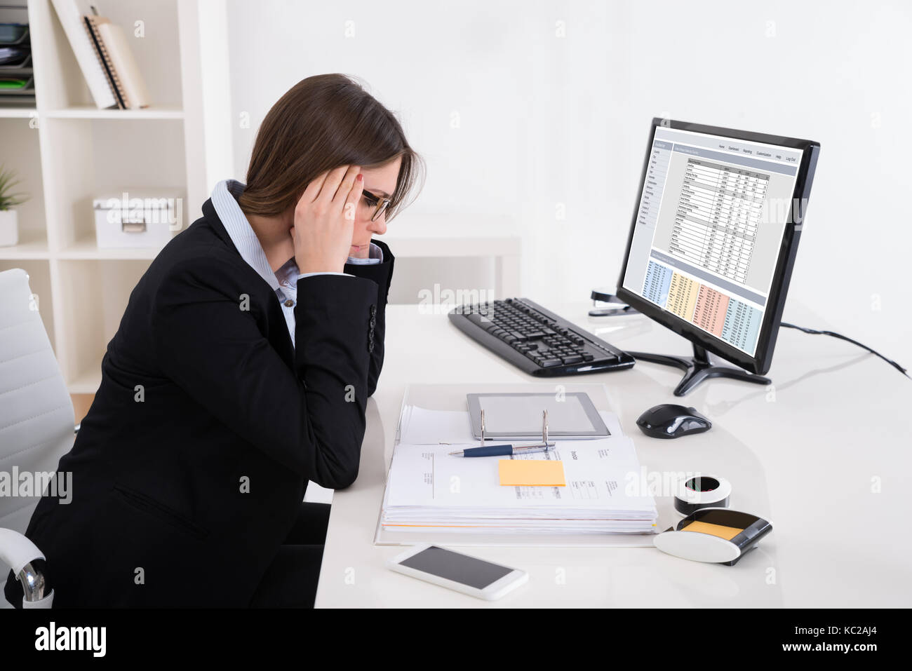 Young Businesswoman Suffering From Headache At Workplace Stock Photo ...