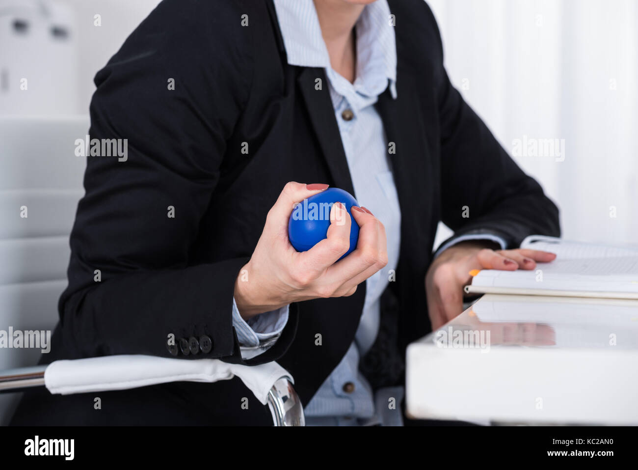 Woman squeezing blue ball hi-res stock photography and images - Alamy