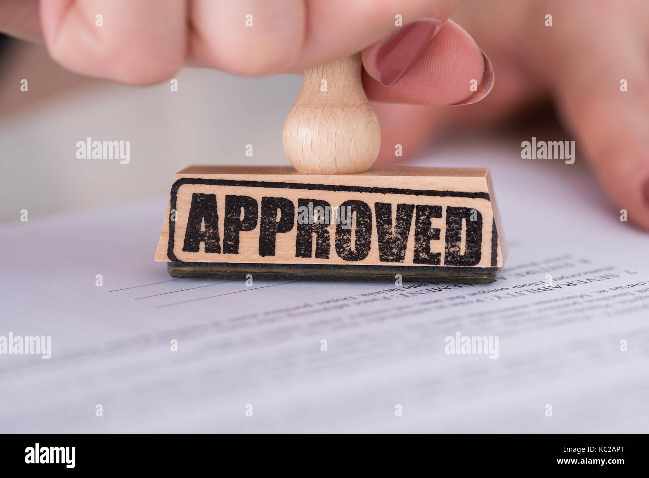 Close-up Of Person Hand Stamping Approved On Paper Stock Photo - Alamy