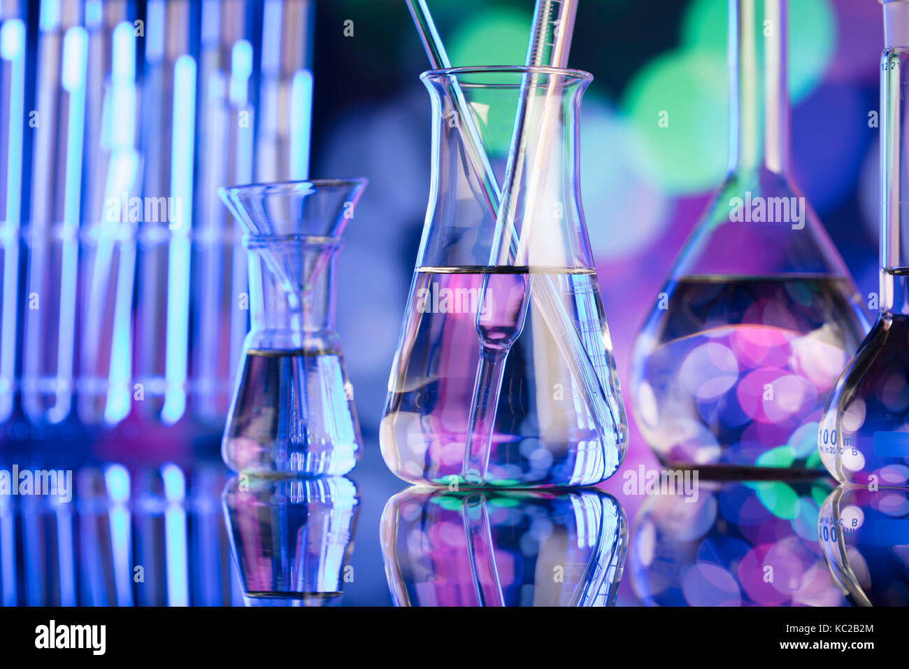 Laboratory concept. Beakers and test-tubes. Coloful bokeh background ...