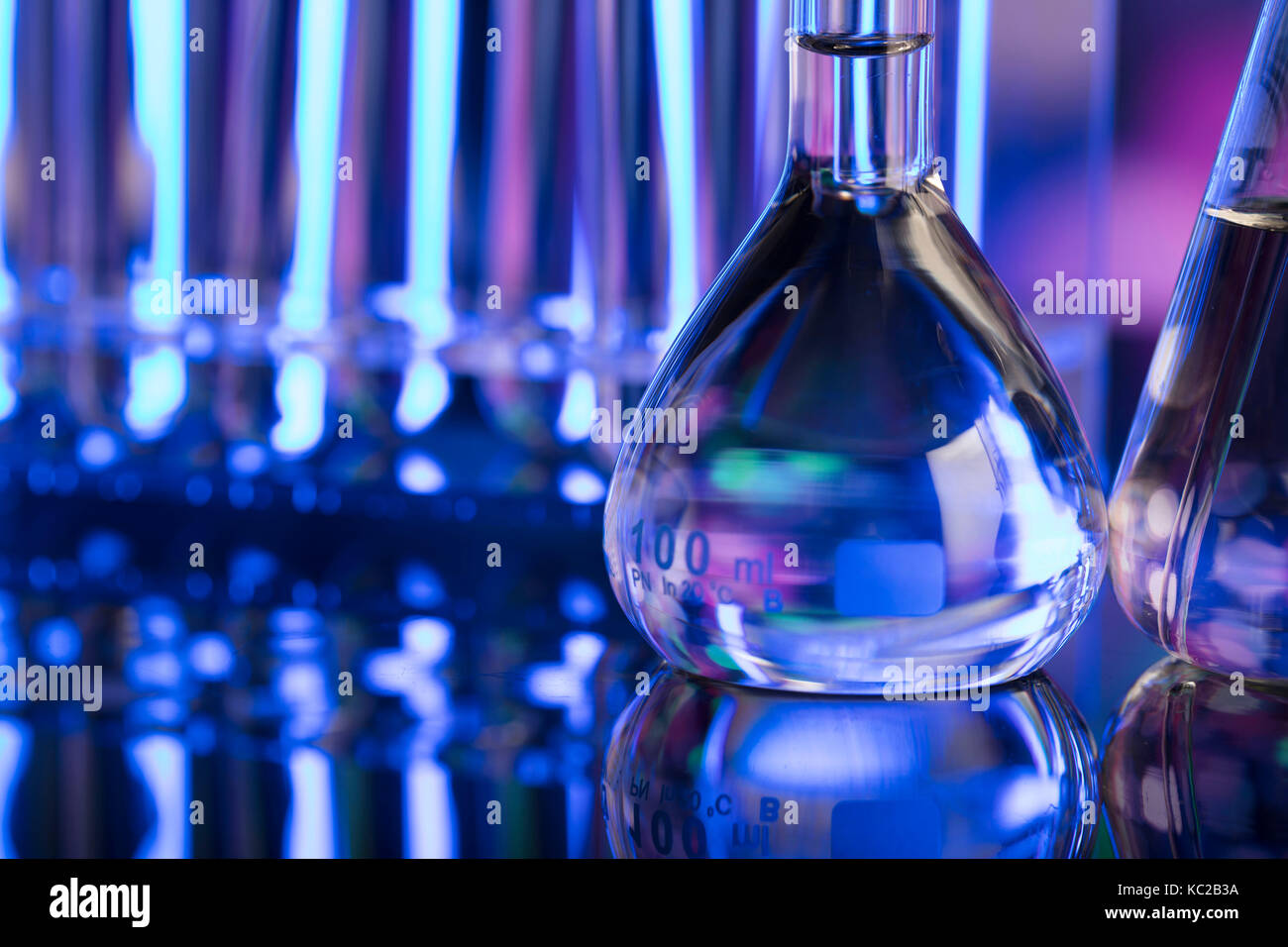 Laboratory concept. Beakers and test-tubes. Coloful bokeh background ...