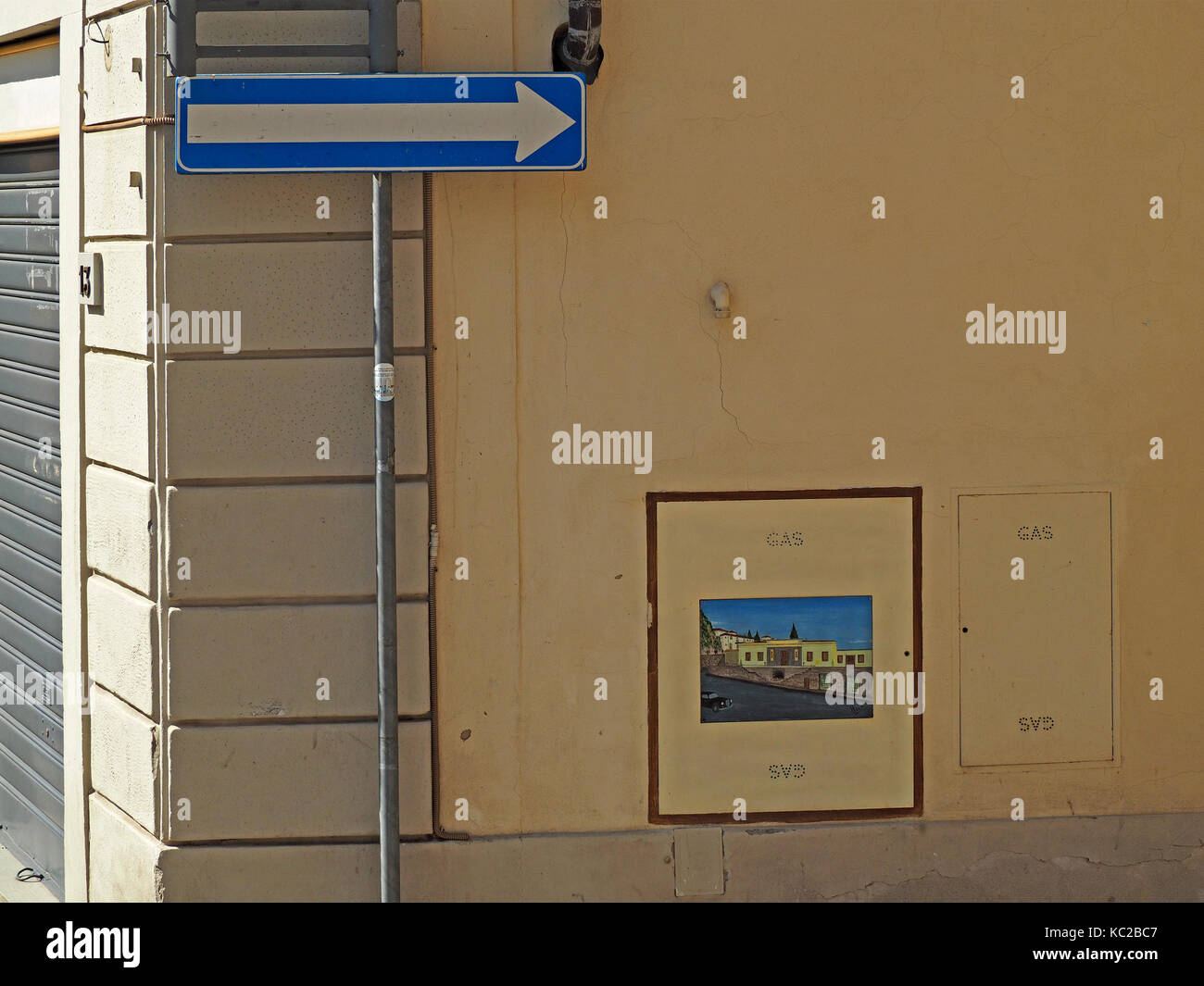 elongated one way traffic sign alongside decorated gas service door in ...