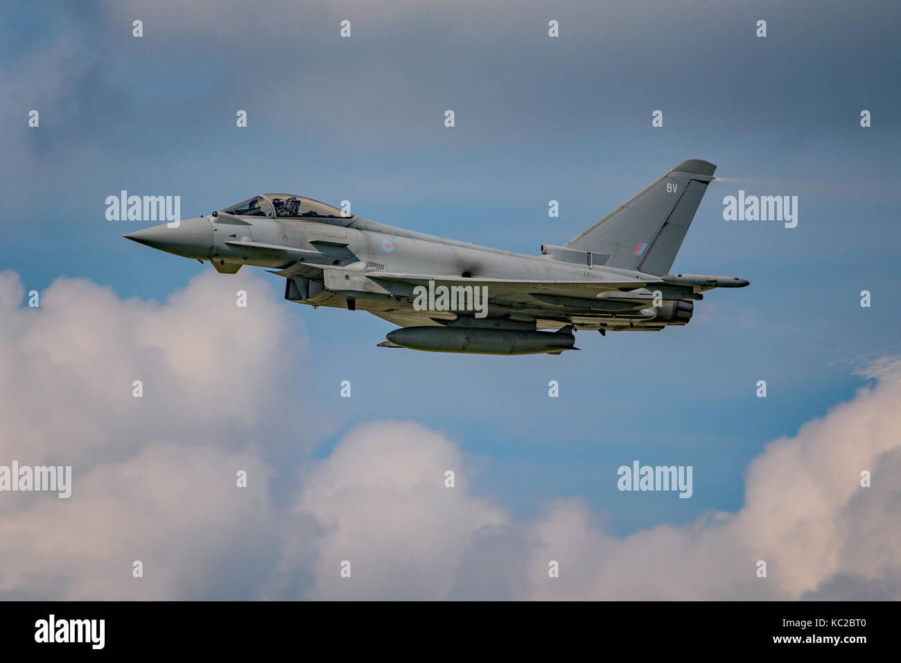 RAF Typhoon FGR4 fighter against a background of blue sky and white ...