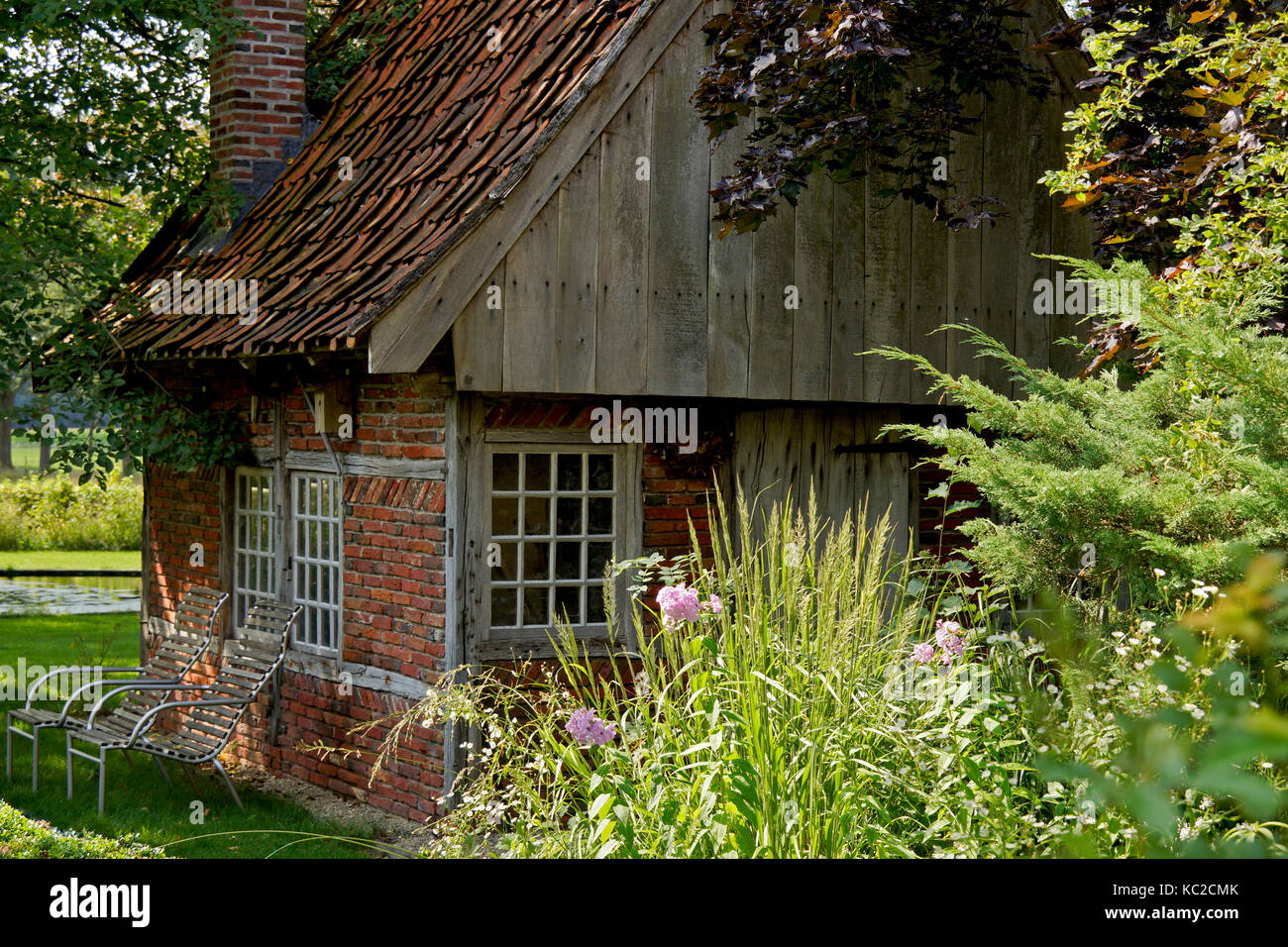 Ancient cottage in a garden Stock Photo - Alamy