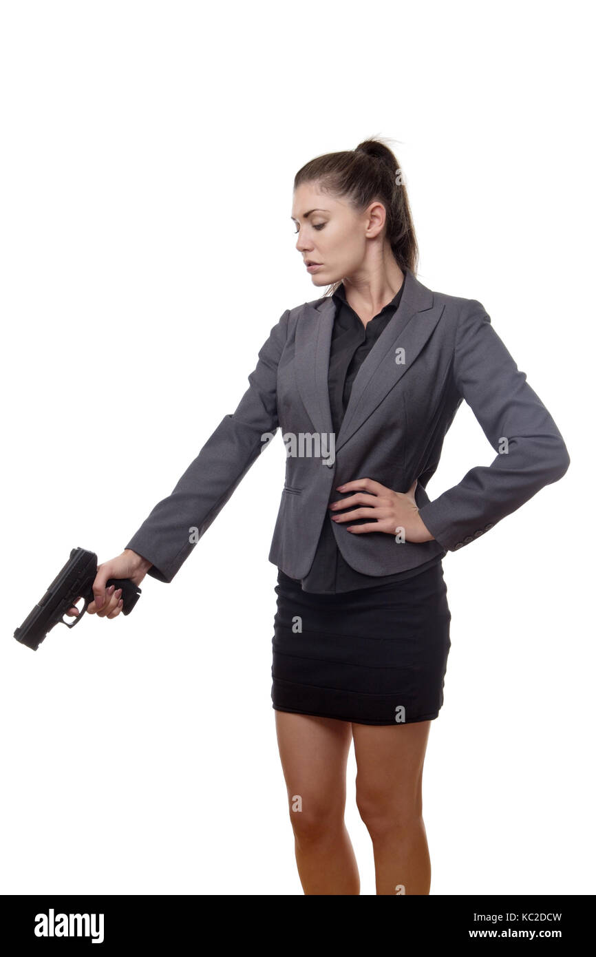 business woman pointing a gun down at something on the ground Stock ...