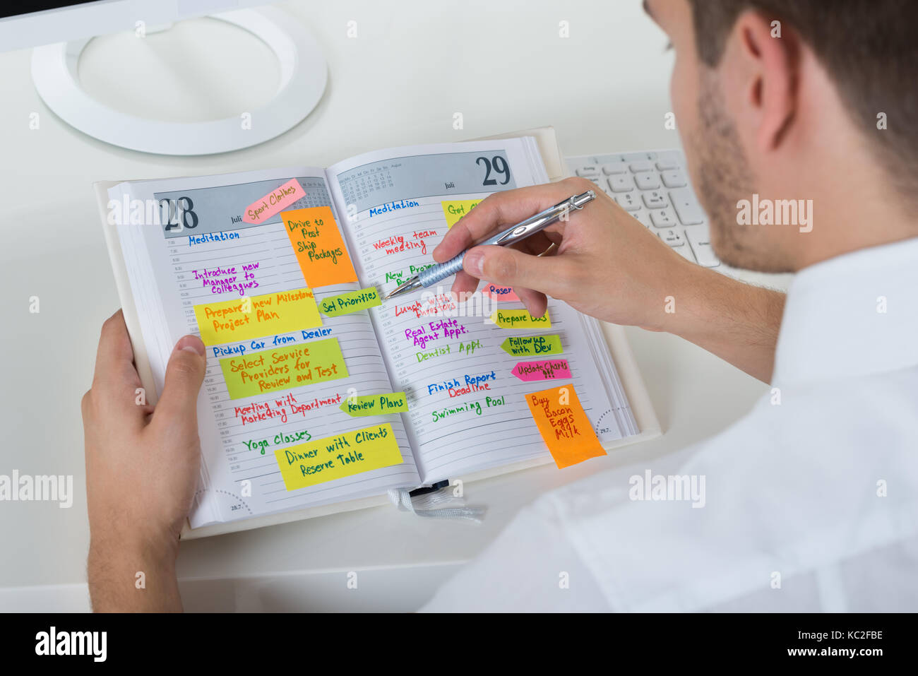 Close-up Of Businessperson Looking At The List Of Office Work In Diary ...