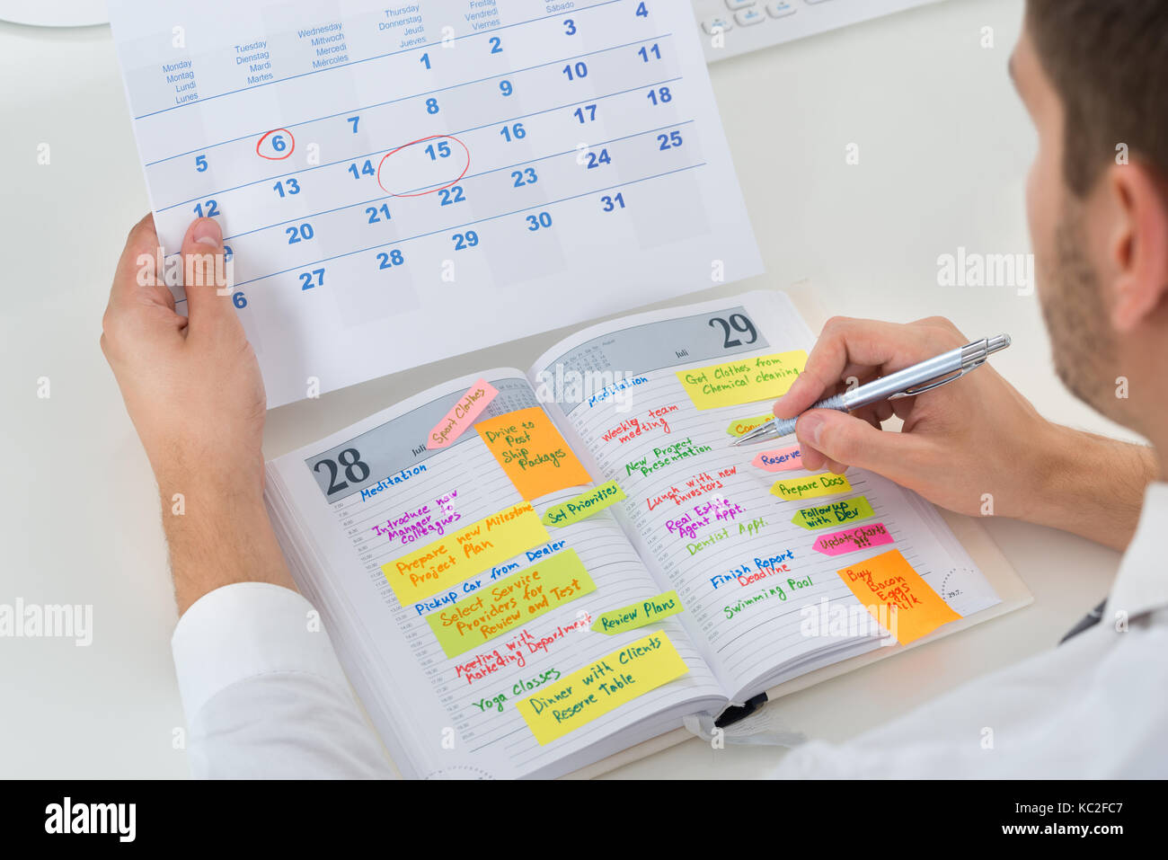 Close-up Of Businessman With Calendar Writing Schedule In Diary Stock ...