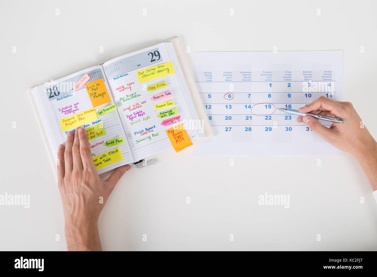 Close-up Of Person Hands Highlighting Date On Calendar With Diary At ...