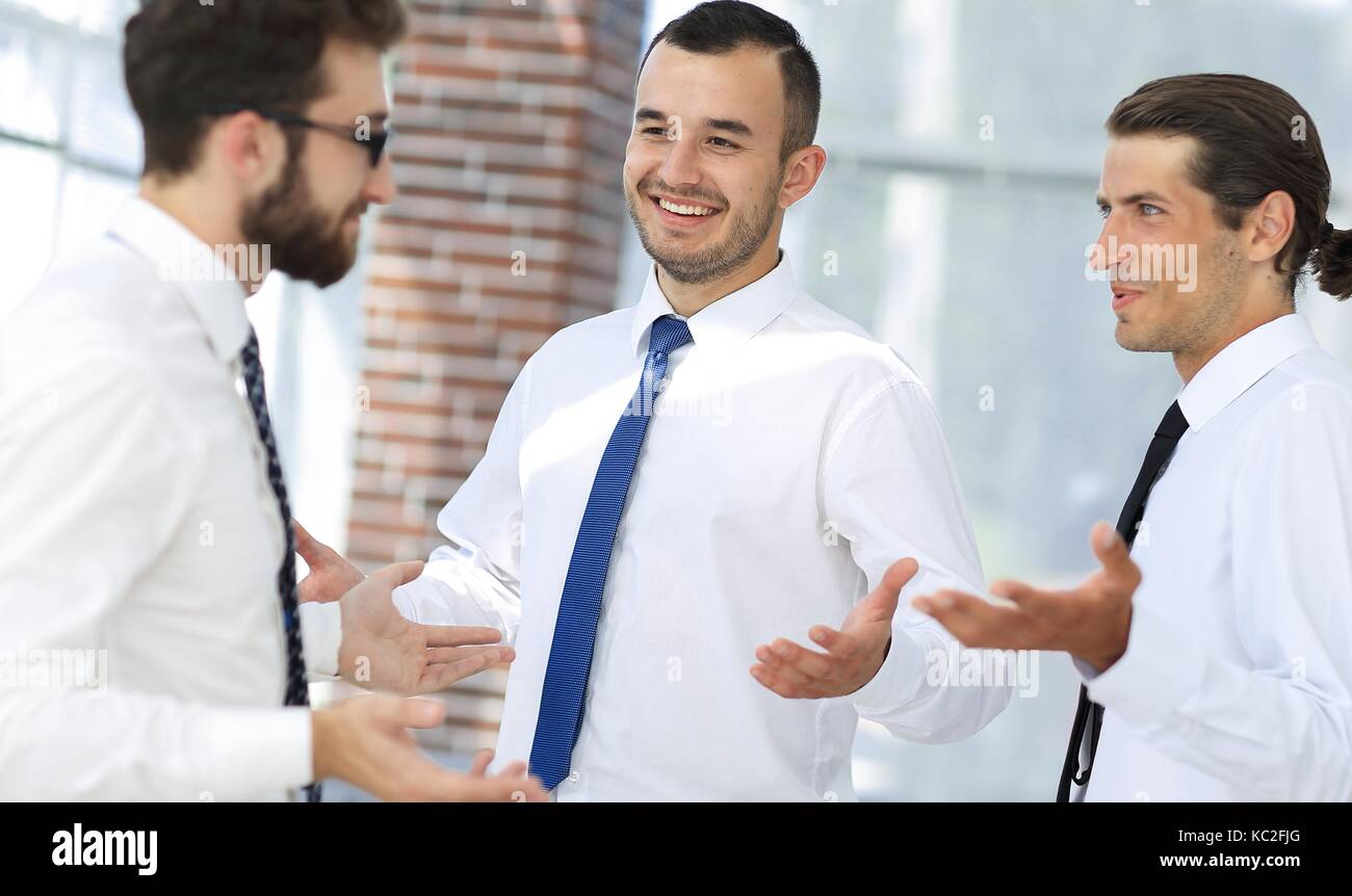 employees are talking ,standing in the office Stock Photo - Alamy