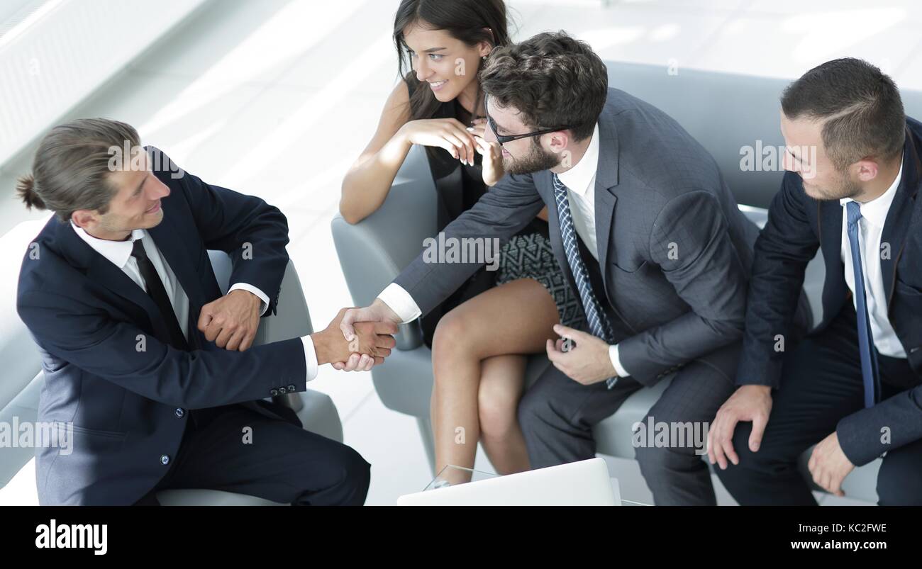 handshake Manager and the client sitting in the office lobby Stock ...
