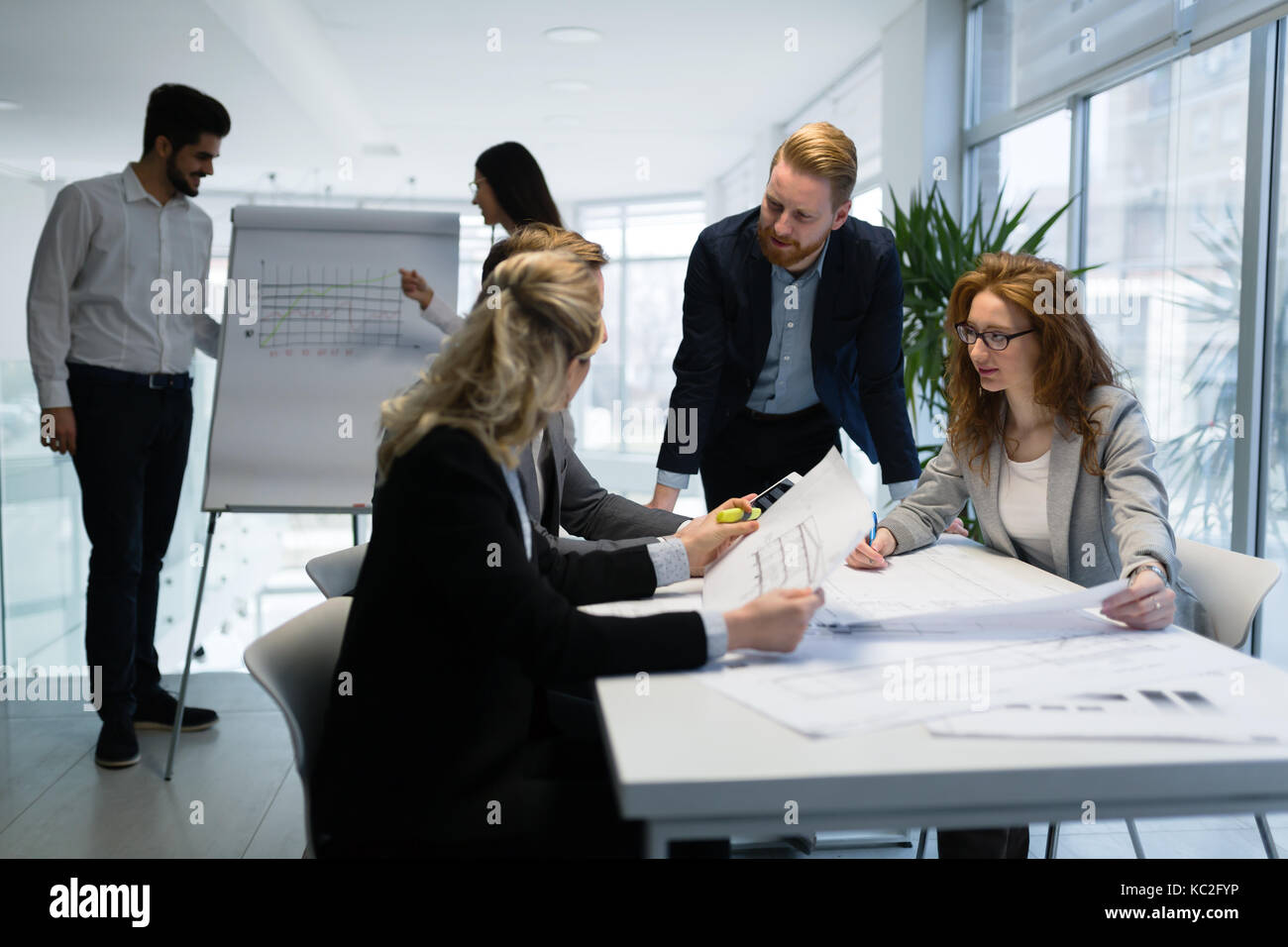 Group of architects working together on project Stock Photo - Alamy