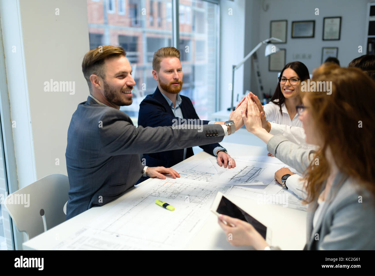 Group of architects working together on project Stock Photo - Alamy