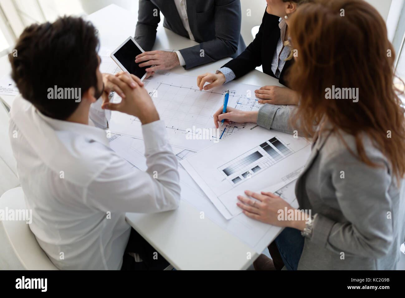 Group of architects working together on project Stock Photo - Alamy