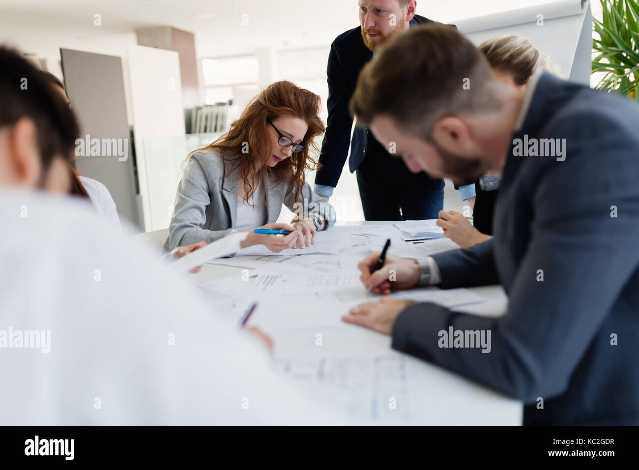 Group of architects working together on project Stock Photo - Alamy
