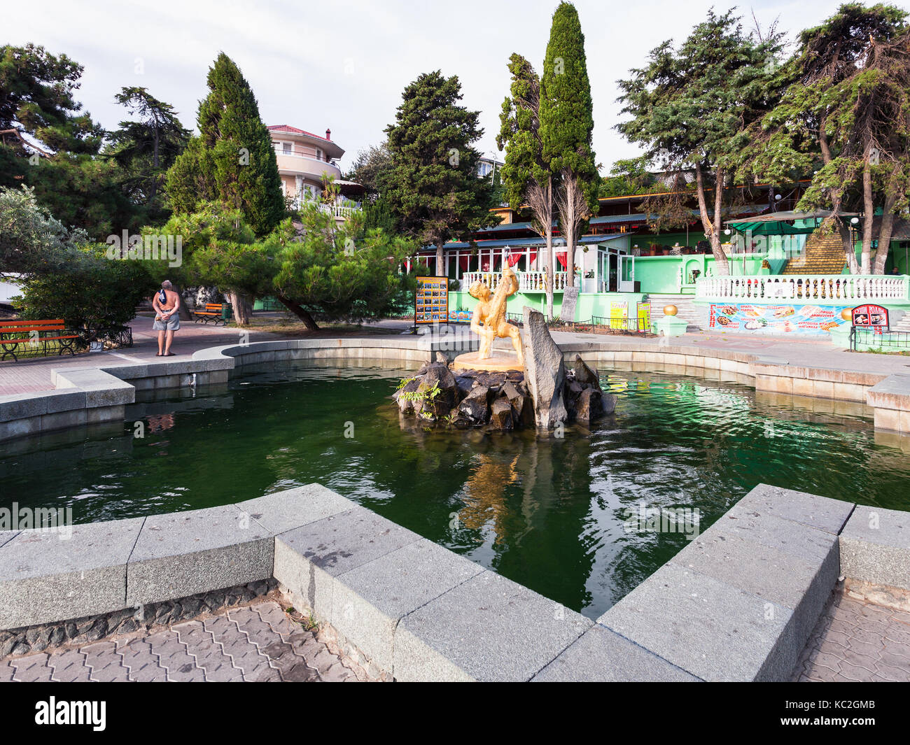 ALUSHTA, CRIMEA - SEPTEMBER 21, 2017: tourist near fountain Boy with ...