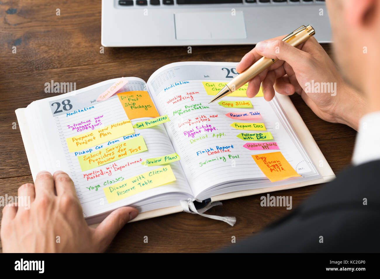 Close-up Of Businessperson Reading List Of Work In Diary Stock Photo ...