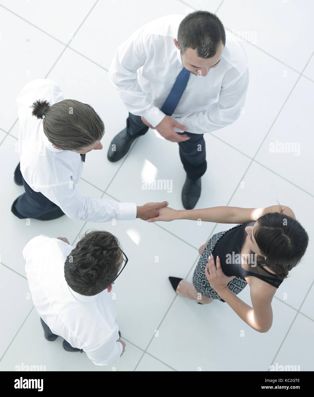 view from the top.welcome colleagues shaking hands in office Stock ...