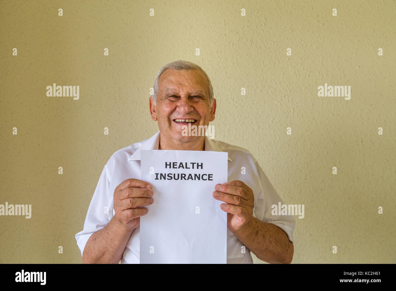 pensioner showing health insurance board Stock Photo - Alamy